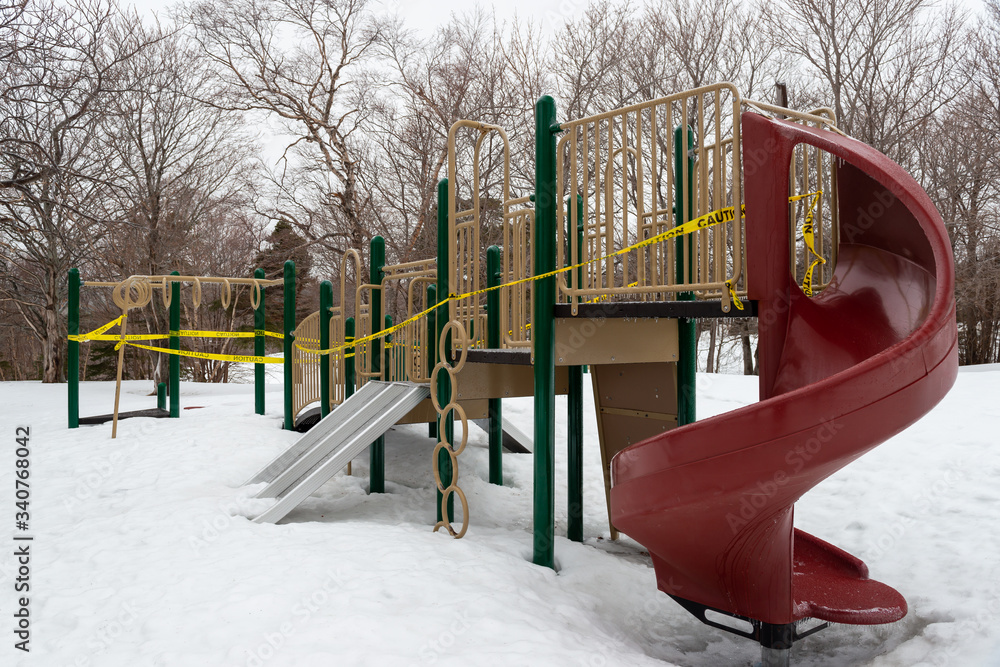 Jungle gym at a playground in a park with a red slide, hoops, slide ...