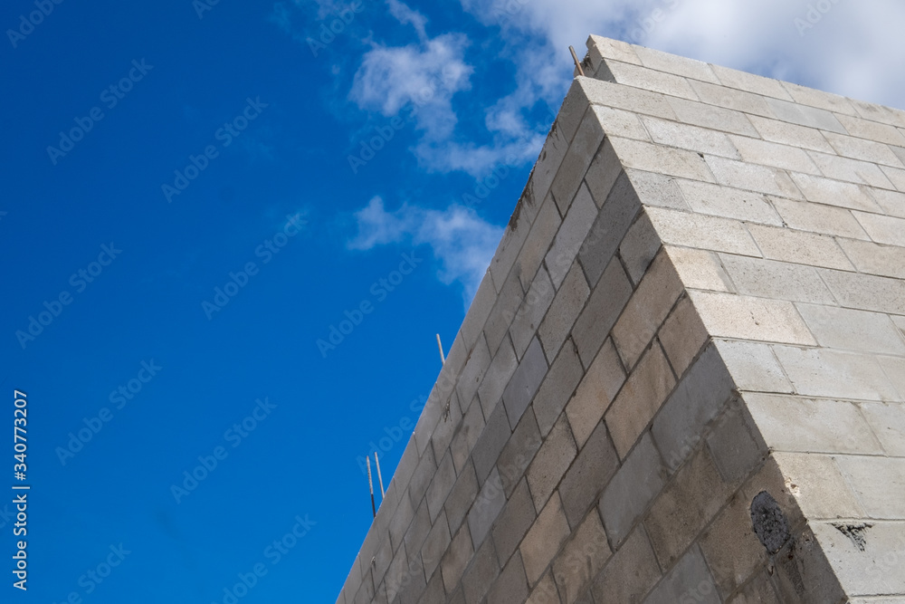 A large newly constructed concrete block building. The view is of the ...