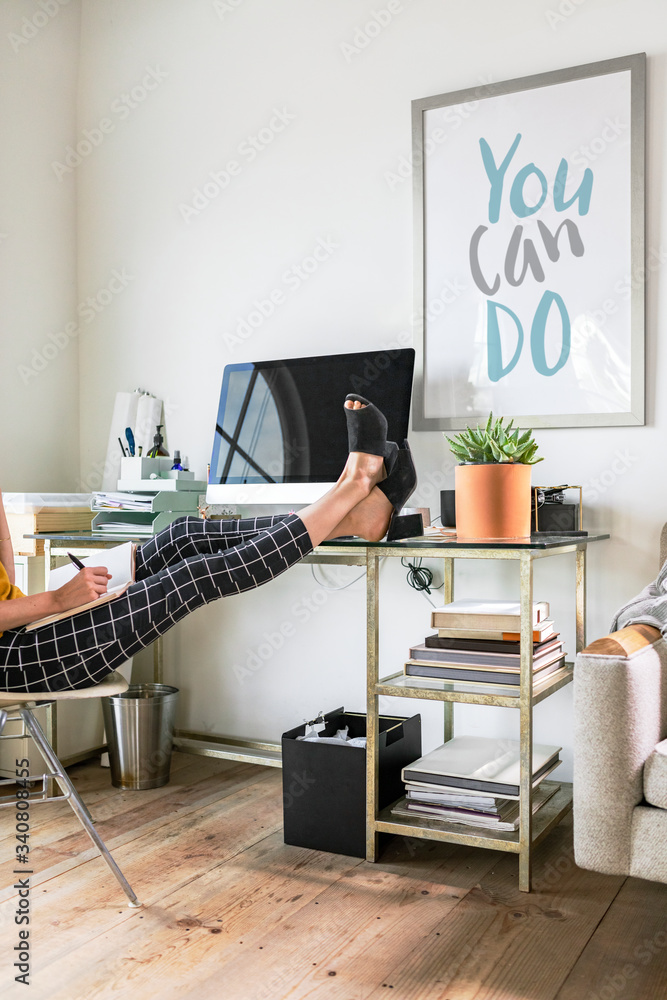 Woman sitting with her legs up Stock Photo | Adobe Stock