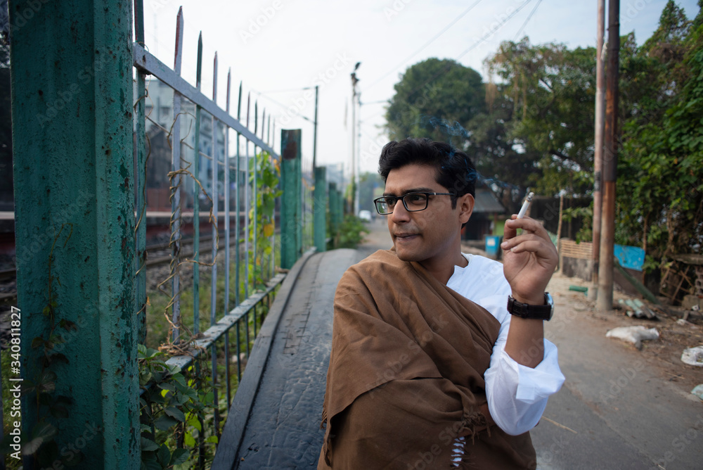 Portrait of an young Indian Bengali detective with traditional wear ...