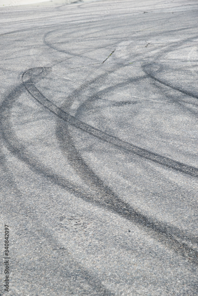 Tire marks in the road from cars doing donuts. Stock Photo | Adobe Stock
