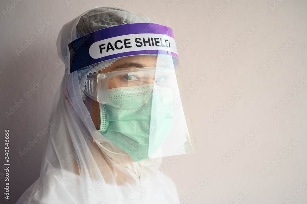 Nurse wearing PPE suit, Face shield and surgical mask for protect ...