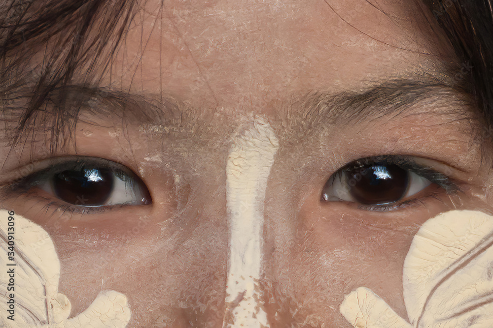 Eyes and part of a face with traditional thanaka powder of an anonymous ...