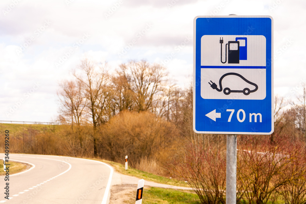 Electric car charging point sign in nature. EV parking and recharging ...
