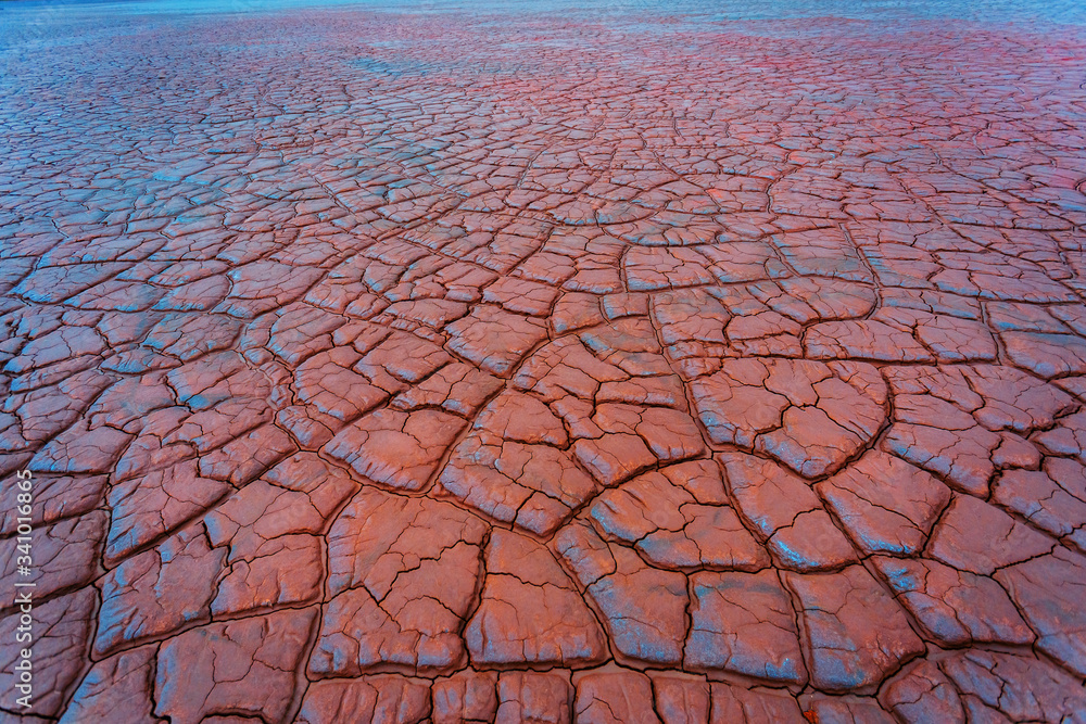 Abstract red and blue ground background. Dry and cracked ground land ...