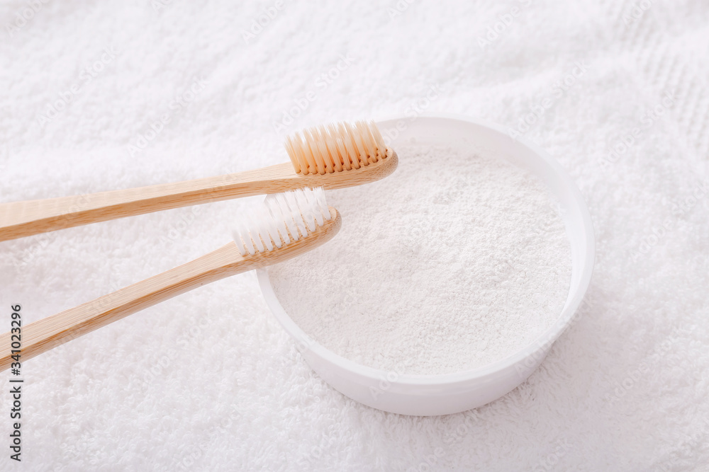 Wooden teeth brushes and tooth-powder on white towel backgroud. Zero ...
