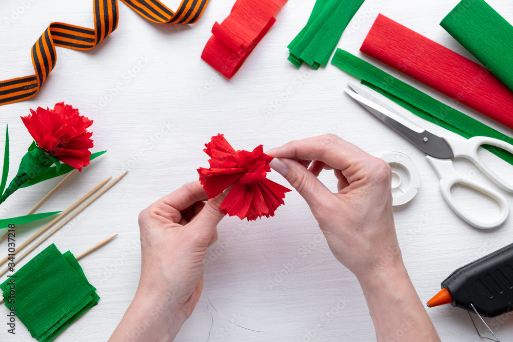 How to make carnation flower at home. Hands making red carnation to ...