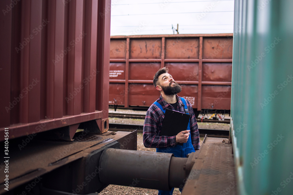 Railroad inspector checking freight train at the station. Freight ...