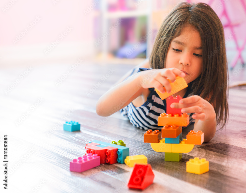 Little Girl Playing With Construction Blocks at Home Stock Photo ...