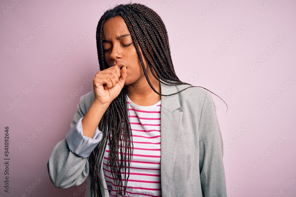Young african american business woman standing over pink isolated ...