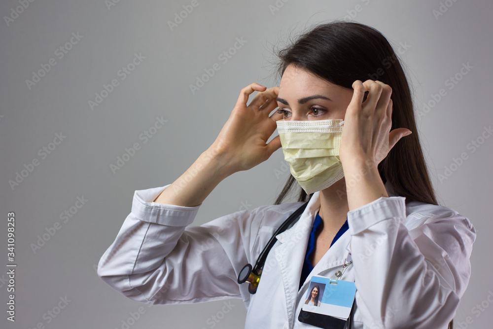 Woman healthcare professional demonstrating proper donning of mask for ...
