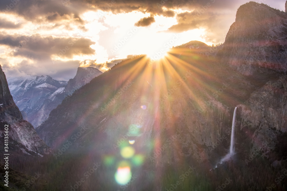 Sun rising above Sentinel Dome, casting golden light on Yosemite Valley ...