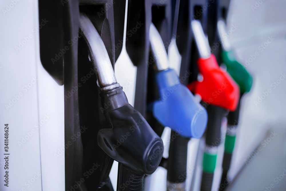 Pumping red green blue black Guns for refueling at a gas oil diesel ...