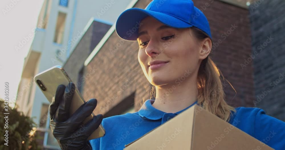 Caucasian young pretty woman in blue uniform, hat and gloves with ...