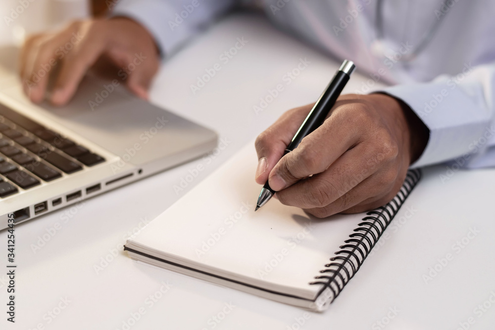 Male medicine doctor, physician or practitioner in lab room writing on ...