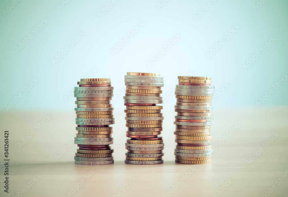 Money concept: Coins tacked on each other. Inflation, currency, savings ...