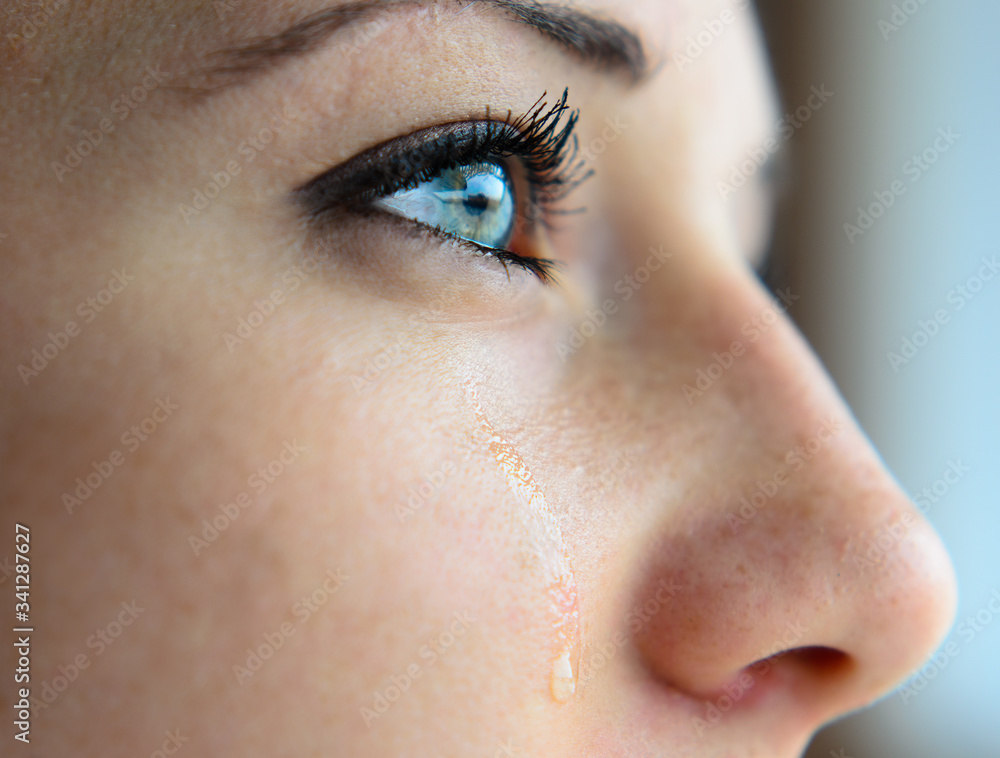 Blue eyes of a young girl crying (close-up) Stock Photo | Adobe Stock
