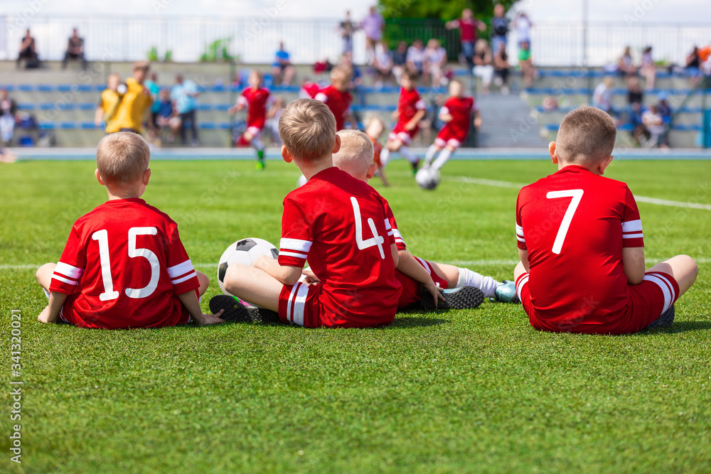 Junior Level Kids Sports Team Sitting on Grass Field. Football Soccer ...