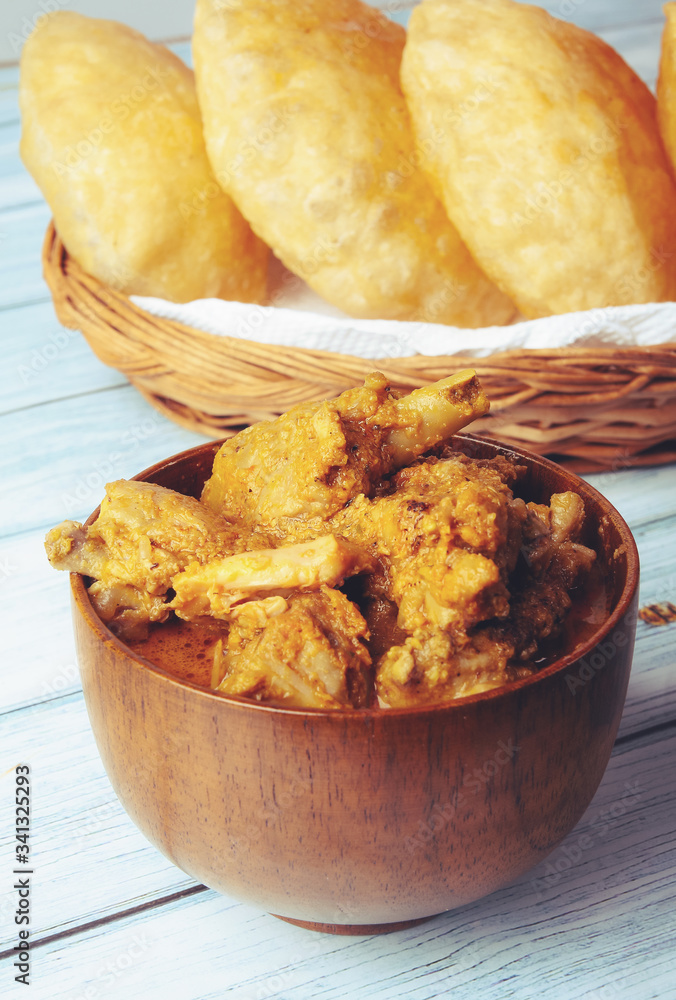 South Indian traditional food Poori or puri with country chicken curry ...