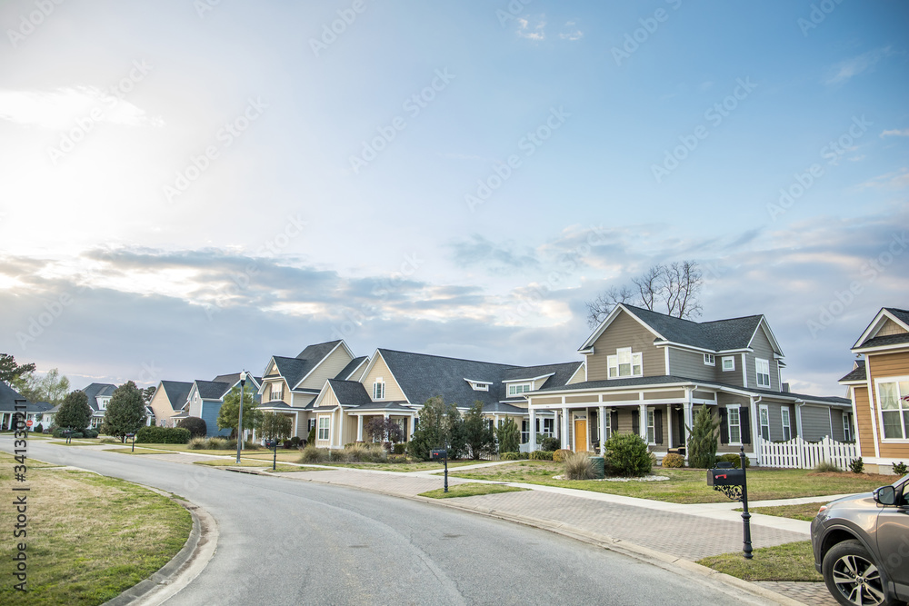 A street view of a new construction neighborhood with larger landscaped ...