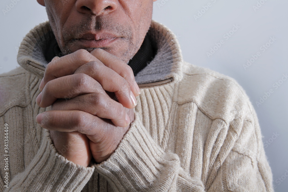 man praying to god with hands together Caribbean man praying with white ...