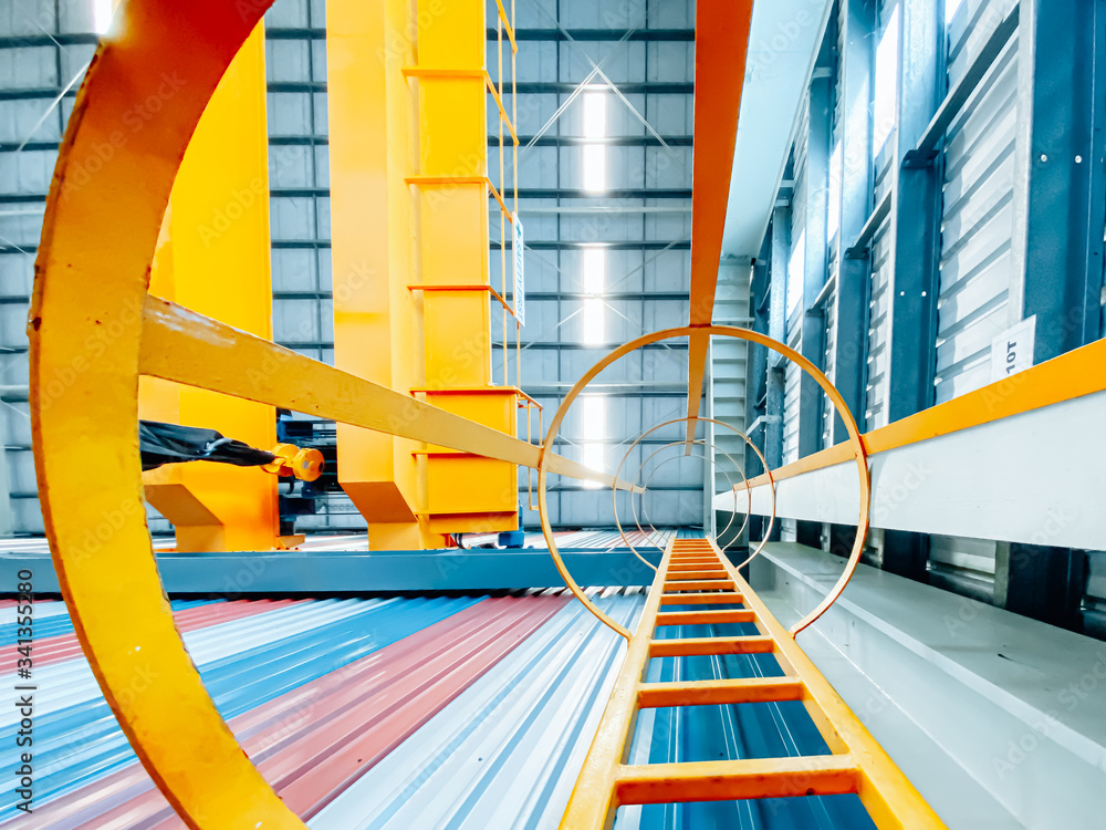 Overhead crane and fixed ladder inside factory building, industrial ...