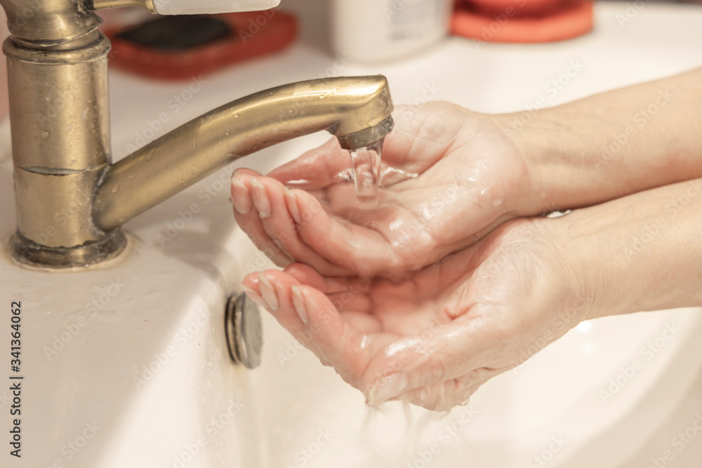 Washing hands under the faucet with water. Washing hands with soap and ...