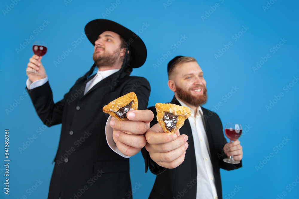Dancing with wine, having fun. Portrait of a young orthodox jewish men ...