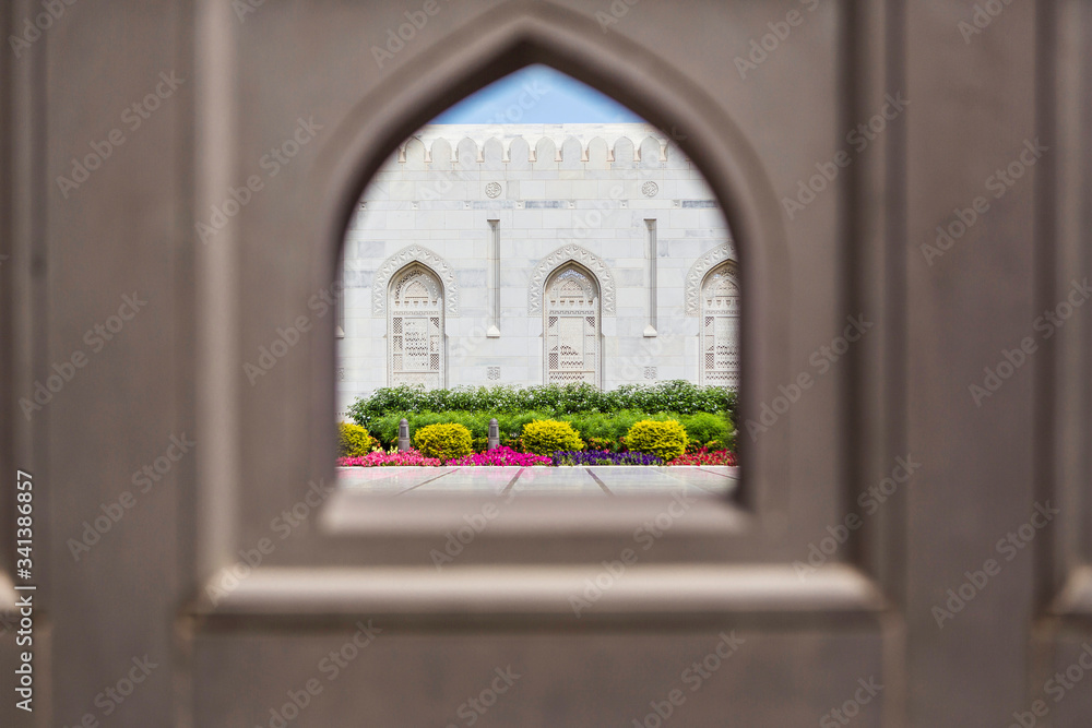 Oman, Muscat, Garden of Sultan Qaboos Grand Mosque seen through arch ...