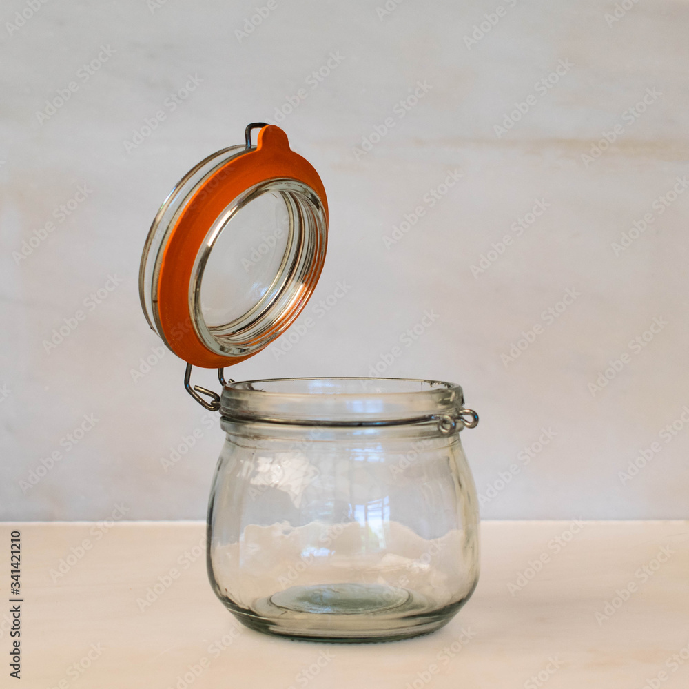 An empty Kilmer round clip top glass storage jar with an orange rubber ...