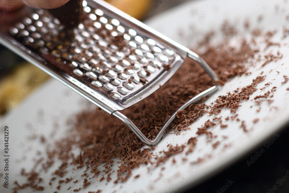 Grate Chocolate Bar Using Handheld Grater. Making Boston Banoffee Pie ...