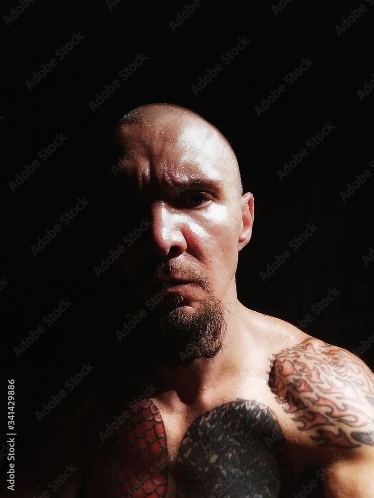 Portrait Of Shirtless Muscular Man Sweating Against Black Background ...