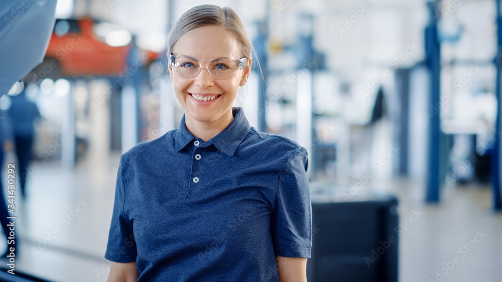Beautiful Empowering Female Car Mechanic is in a Vehicle Service. She ...