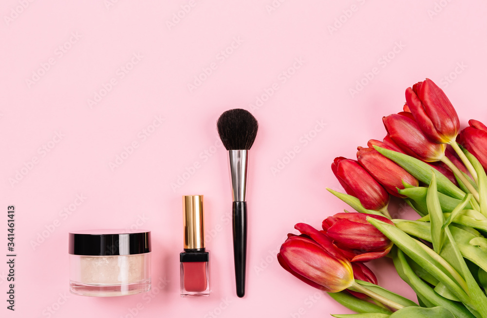 Tools for applying light refreshing makeup lie on a pink background ...