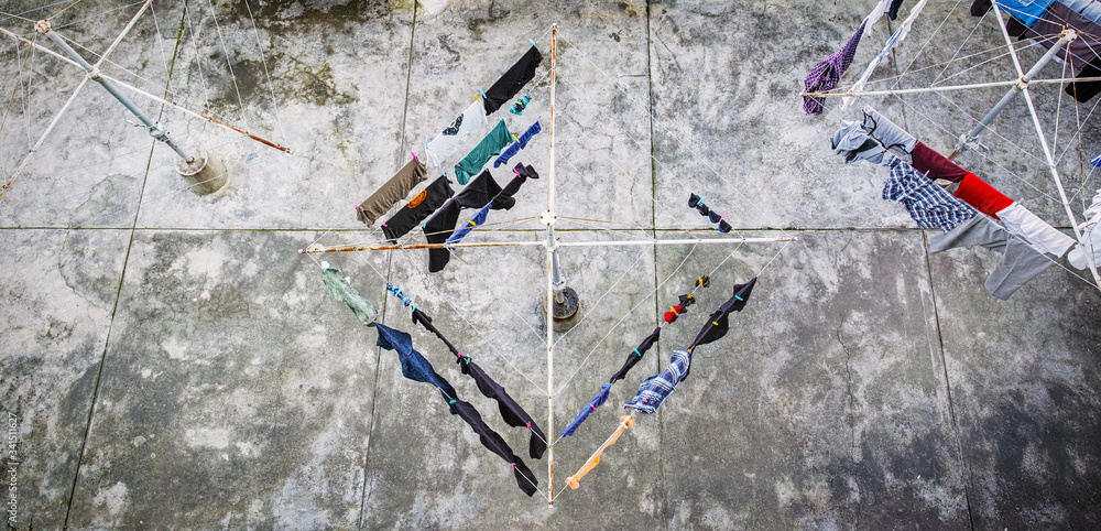 overhead view of a rotary washing line drying laundry in a concrete ...
