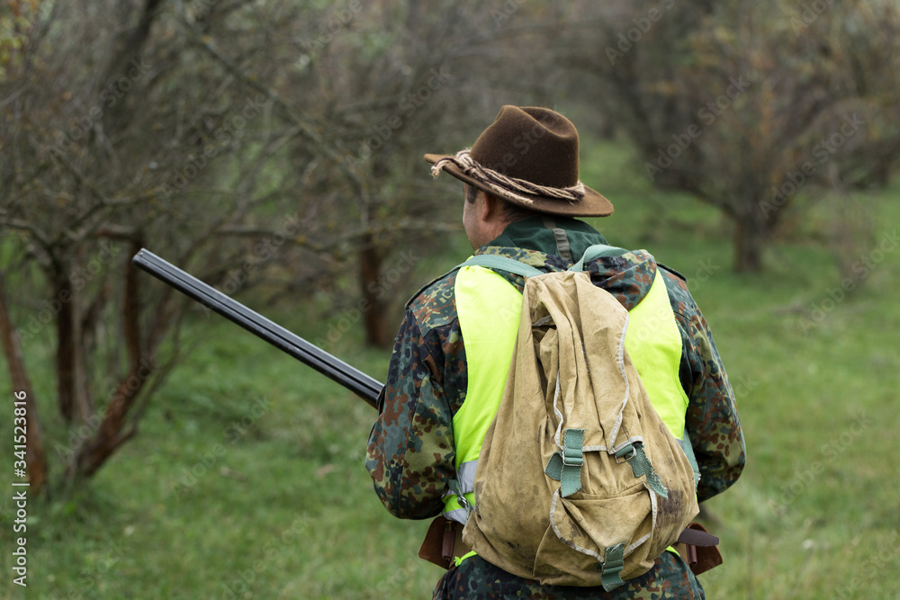 Hunting period, autumn season open. A hunter with a gun in his hands in ...
