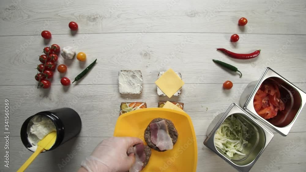 Top view of professional chef cooks a delicious burgers at fast food ...