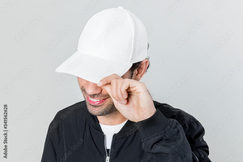 Happy man wearing a white cap Stock Photo | Adobe Stock