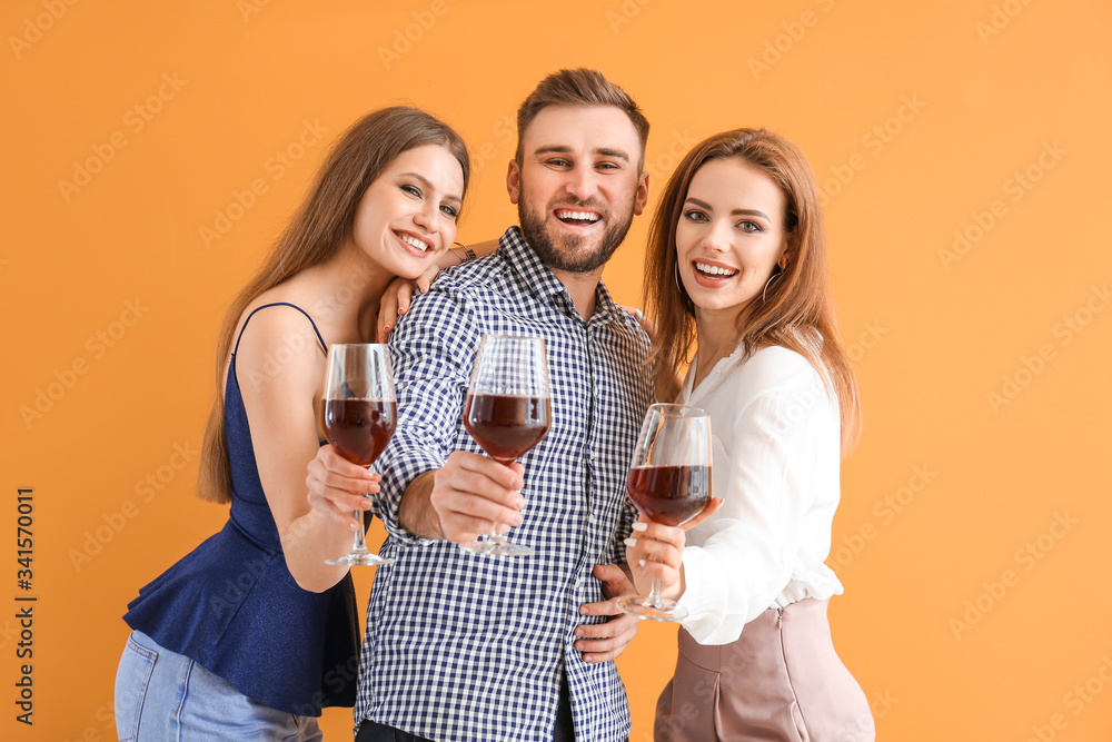 Happy people with glasses of wine on color background Stock Photo ...