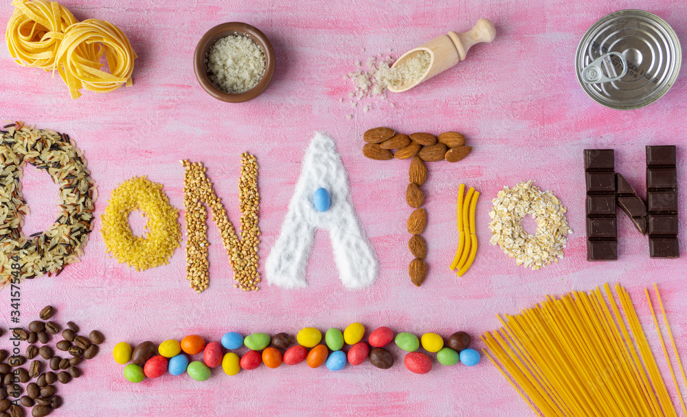 The word donation made of different type of groats, nuts, chocolate and ...