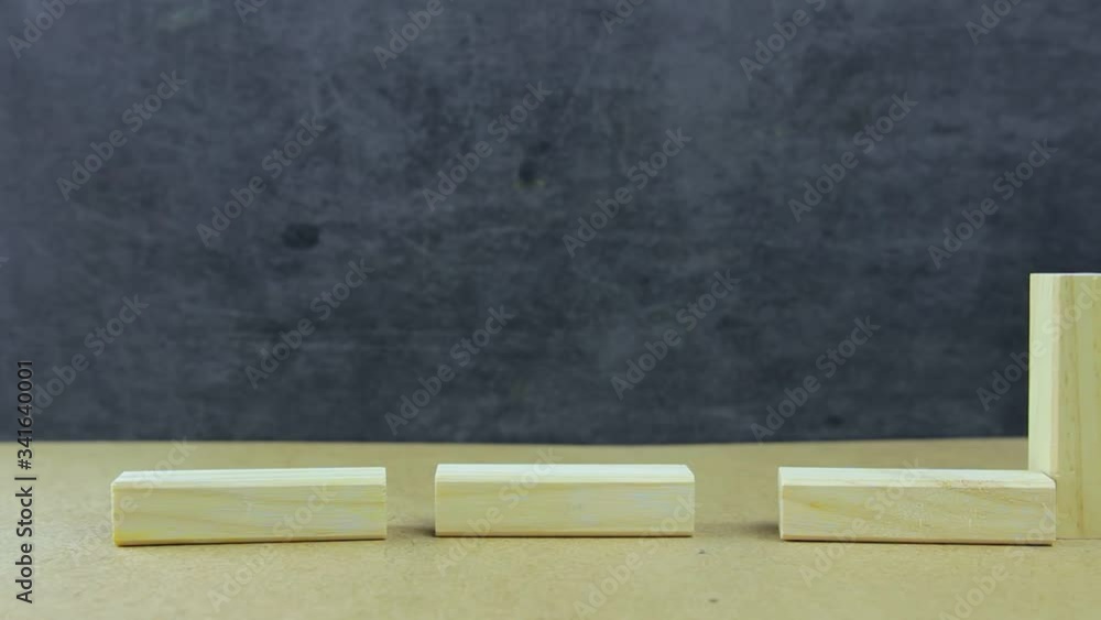 Social distance during a pandemic concept. Side view of falling wooden ...