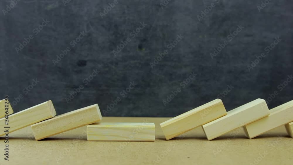 Social distance during a pandemic concept. Side view of falling wooden ...