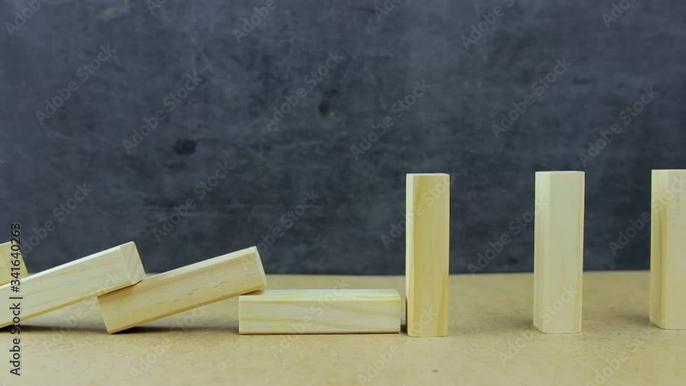 Social distance during a pandemic concept. Side view of falling wooden ...