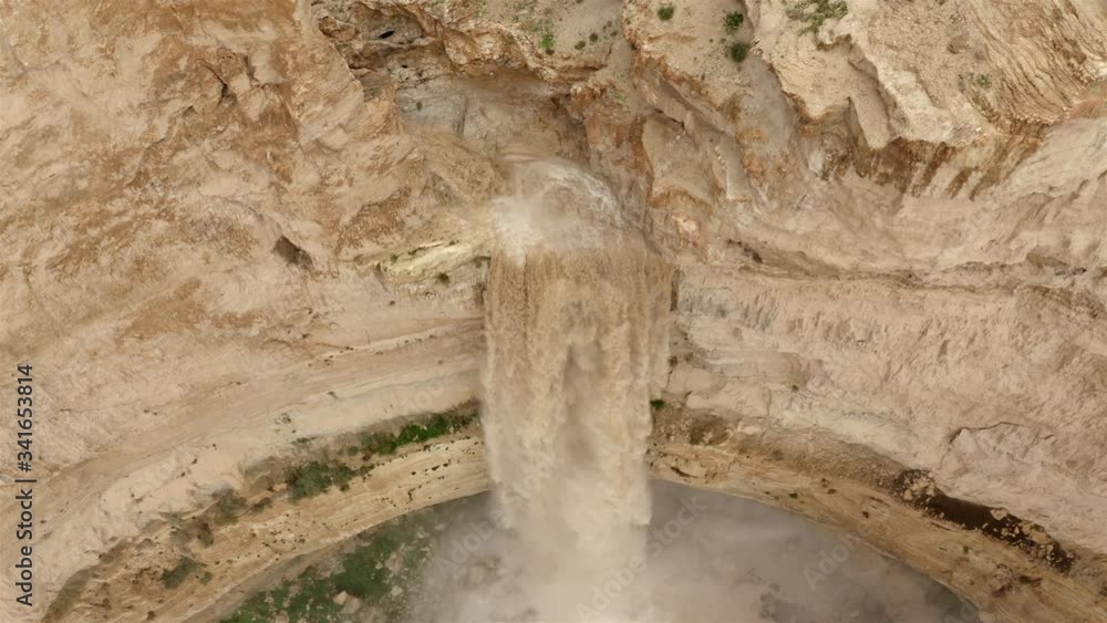 Giant waterfall, flash flood, Water falling into a pool in Wadi-Aerial ...