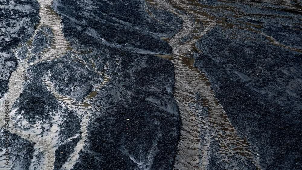 Glacier with ash in the ice with melted water and Icelandic landscape ...