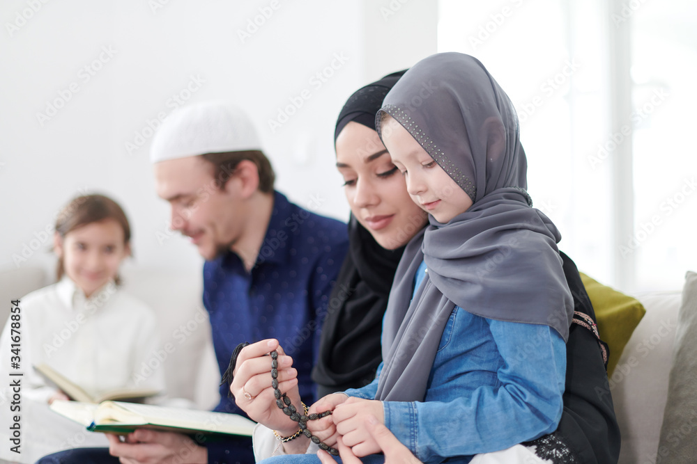 muslim family reading Quran and praying at home Stock Photo | Adobe Stock