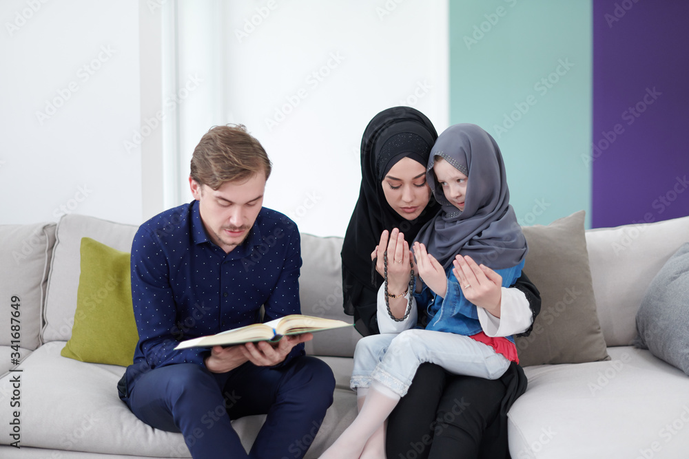 muslim family reading Quran and praying at home Stock Photo | Adobe Stock