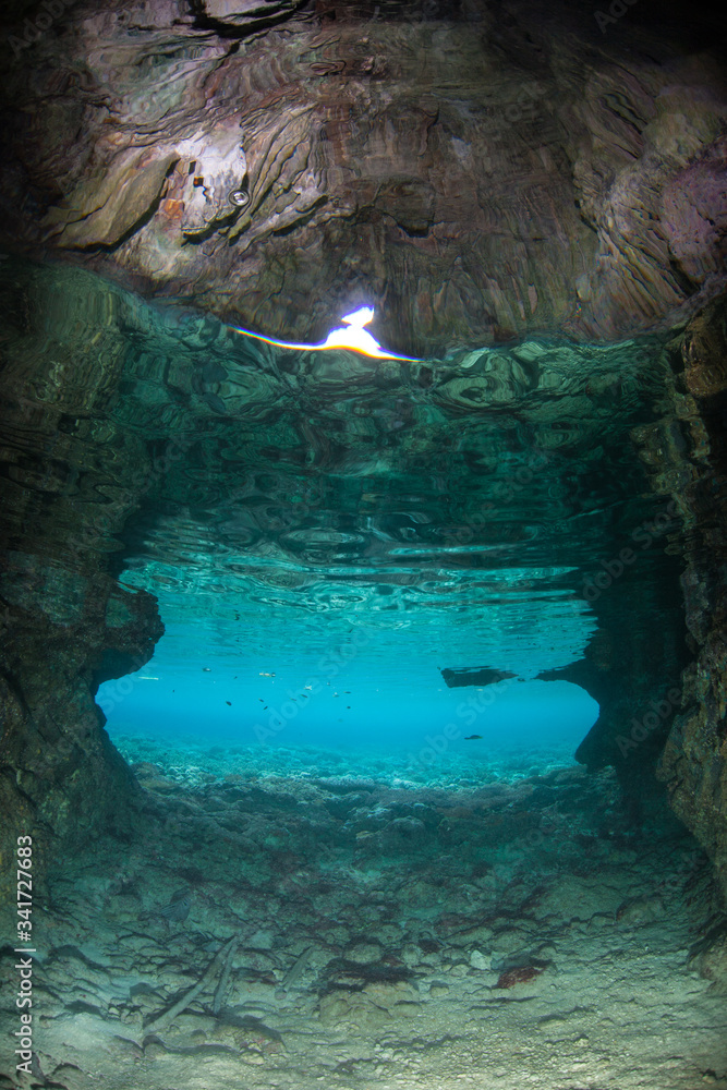 Light seeps into a dark, underwater cavern in the tropical Pacific ...