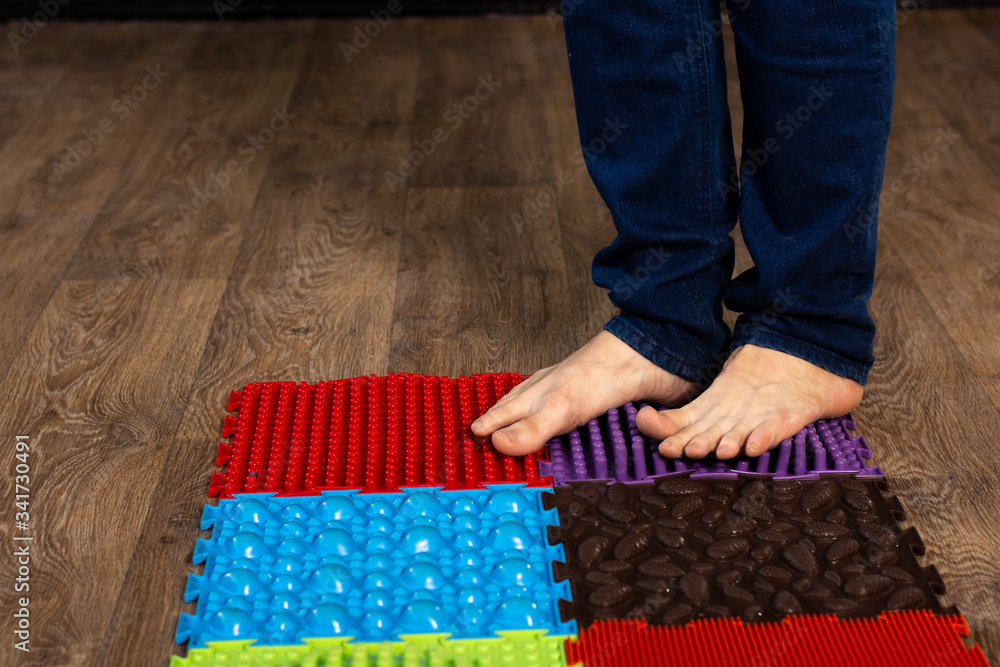 closeup legs on orthopedic rug. varus and valgus staging of feet ...