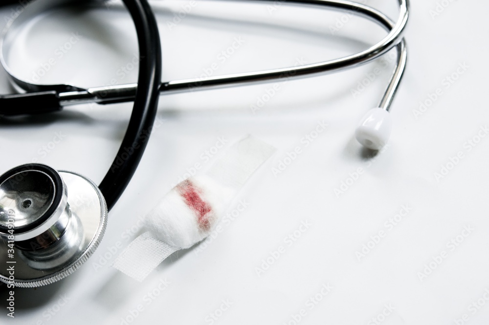 Blood on cotton wool and white plaster on white background with ...